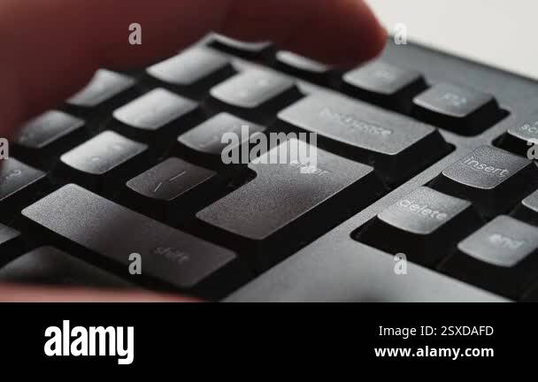 The man hesitates before press the key enter or detele on a desktop pc ...