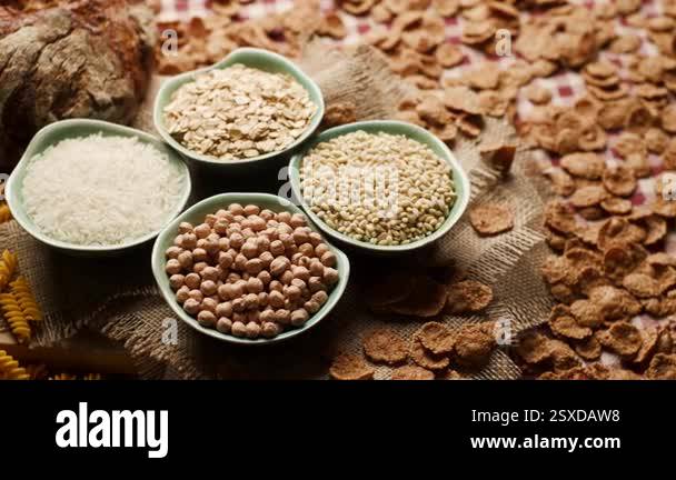 Close-up of assorted carbohydrate-rich foods arranged on a table ...