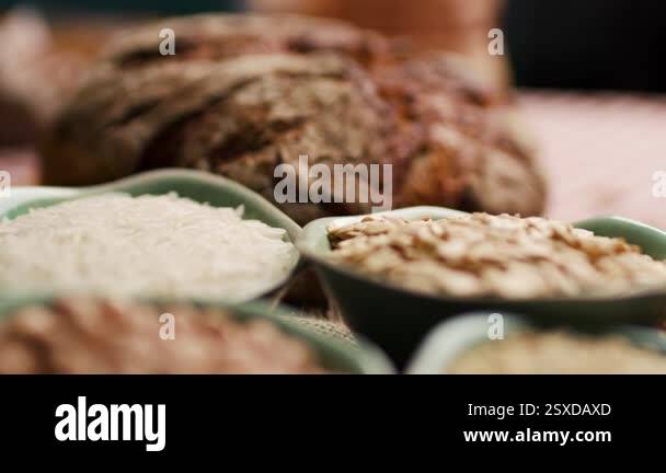 Close-up of assorted carbohydrate-rich foods arranged on a table ...