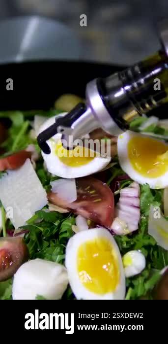Rotating salad bowl with Salad of fresh vegetables and tuna, tomatoes ...