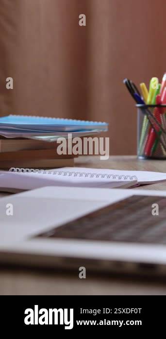 Close-up image of a young womans hand taking notes in a notebook while ...