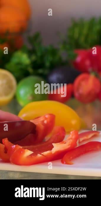 The chef sprinkles stuffed yellow and red peppers, paprika, and stuffed ...