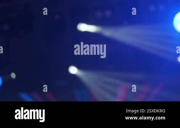 Out-of-focus concert lighting revealing vibrant blue and white ...