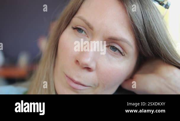 Head shot of young beautiful woman with brown hair look down and lean ...