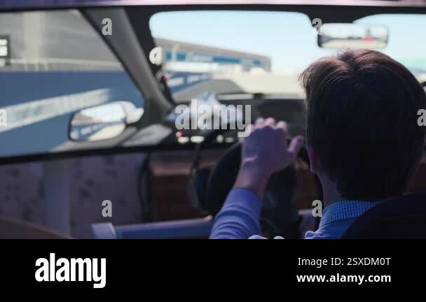 Person interacts with a car racing simulator in immersive environment ...
