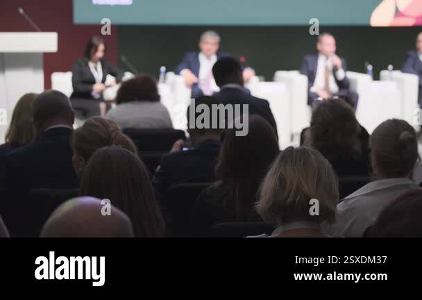 Audience attending a professional conference with speakers sharing ...