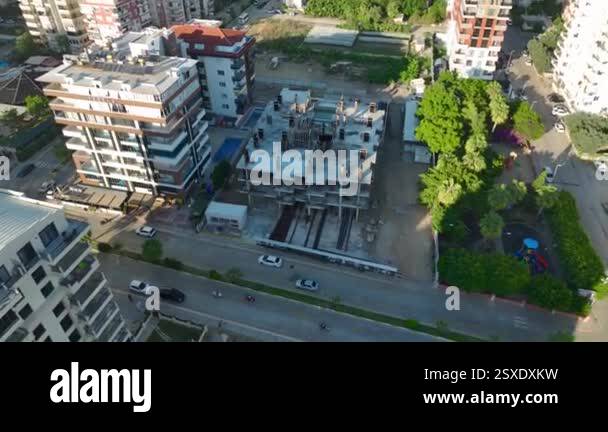 The luxury high-rise construction is progressing, with workers ...