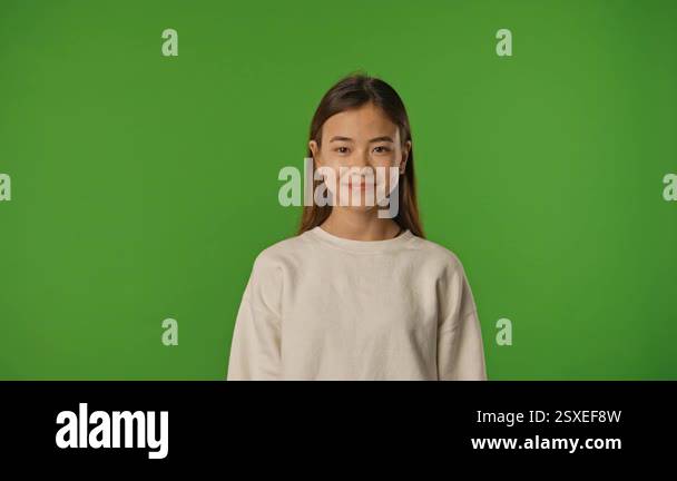 Children emotions concept. Asian girl child in shirt standing looking ...