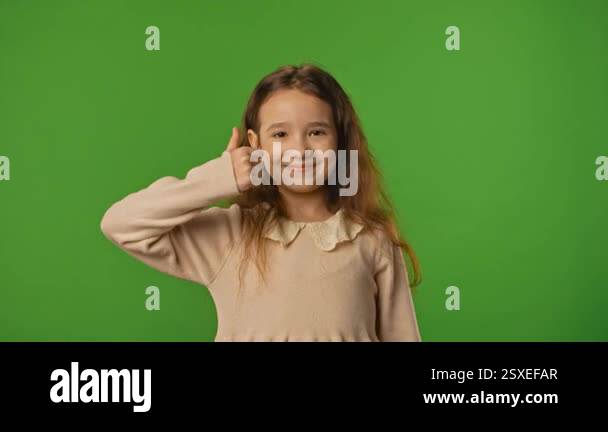 Children emotions concept. Little girl child looks at camera and shows ...