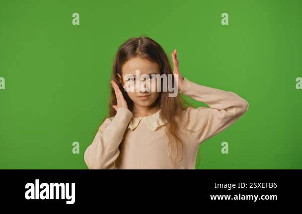 Children emotions concept. Little girl child posing at camera like a ...