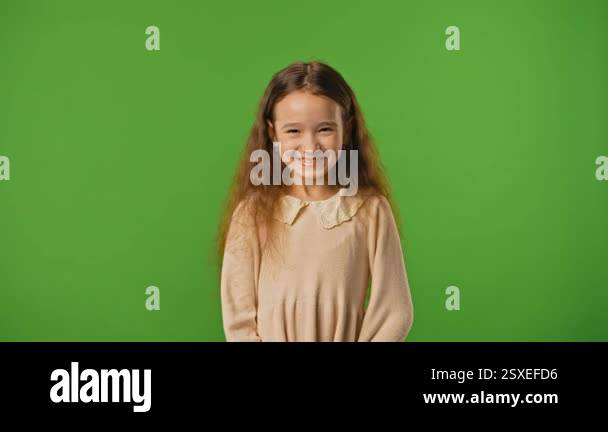 Children emotions concept. Little girl child in shirt standing looking ...