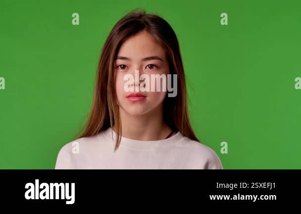 Children emotions concept. Asian girl child in shirt standing looking ...