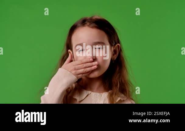 Children emotions concept. Little girl child looks at camera and blows ...
