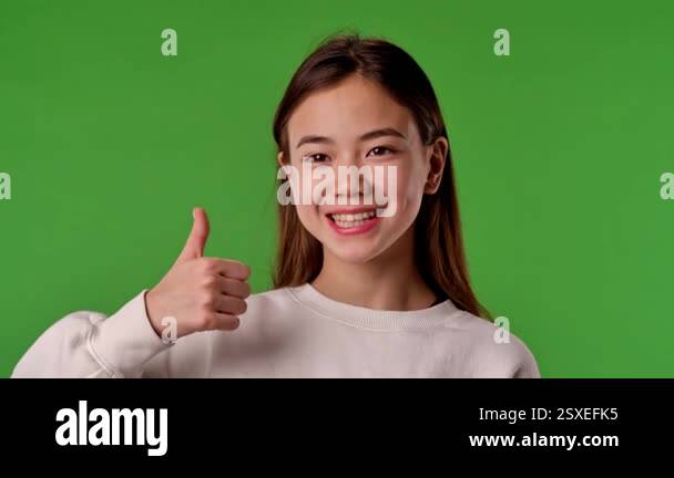 Children emotions concept. Asian girl child looks at camera and shows ...