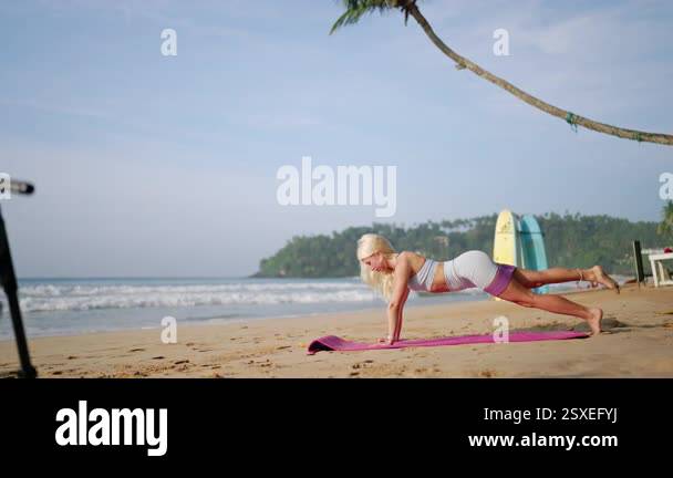 Female trainer streams live workout session, using smartphone on tripod ...