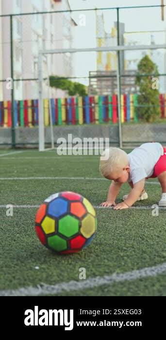 Toddler boy playing on playground in summer under the sun. Child ...