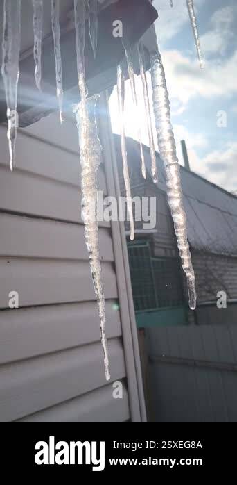 vertical video icicles on the roof. icicles melt in the sun Stock Video ...