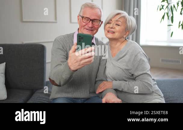 Video call. Happy senior couple woman man with smartphone having video ...
