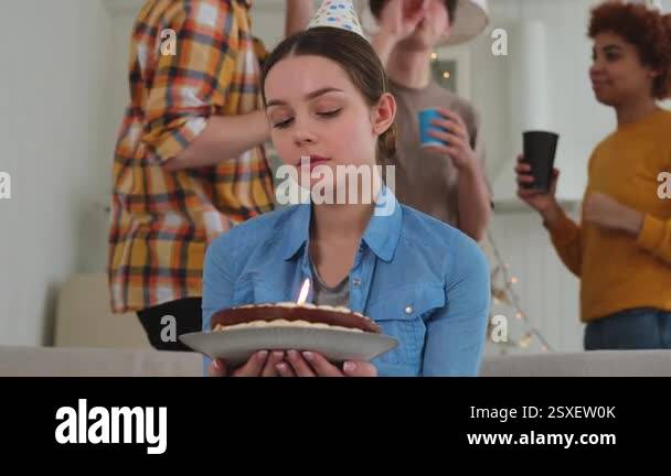 Sad lonely frustrated unhappy young woman looking at birthday cake with ...