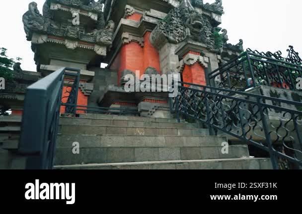 A close-up view of a traditional Balinese temple with intricate stone ...