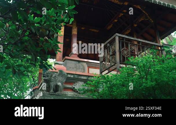 A traditional Balinese structure surrounded by lush greenery, featuring ...