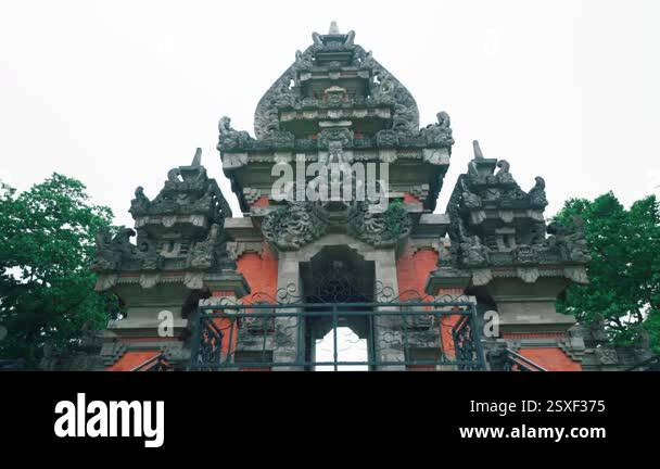A majestic Balinese temple gate with intricate stone carvings ...