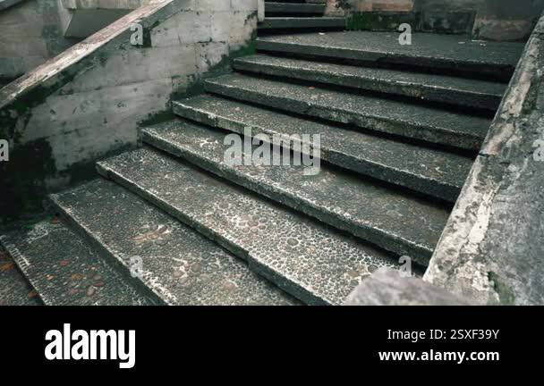 A close-up view of weathered stone stairs with a textured surface ...