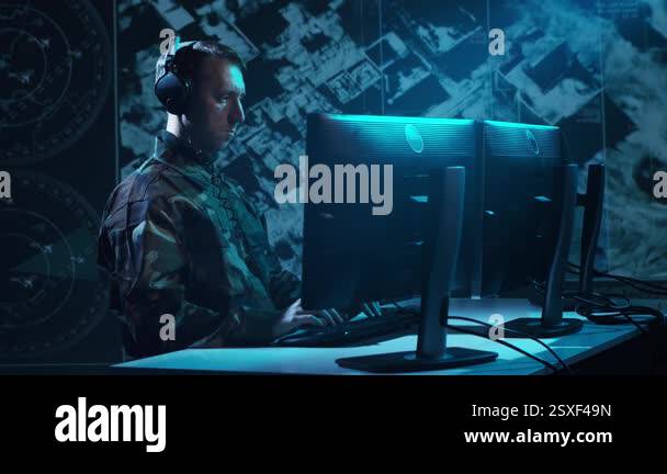 Dramatic scene of a soldier in a dimly lit military control room ...