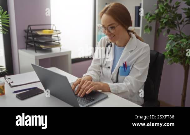 Woman doctor celebrating in clinic office, excited with laptop, happy ...