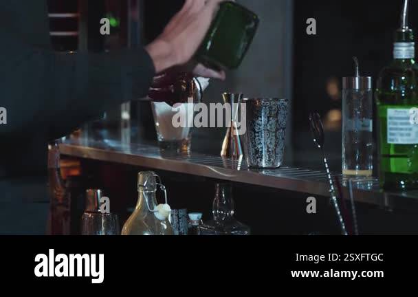 Closeup mixing hand bartender holding jigger to measure liquor sugar into shaker design ...