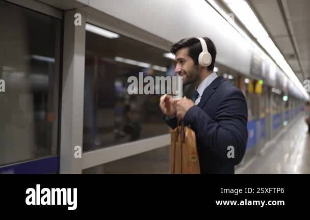 Smart project manager listening music from headphone while train is ...
