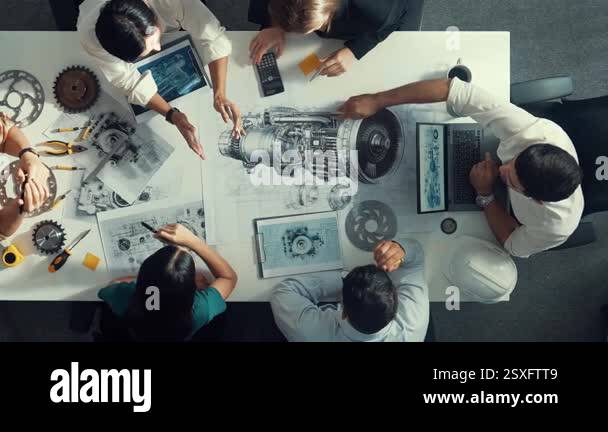 Top down aerial view of smart engineer team working together to design ...