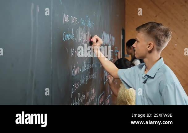 Site view of boy writing code on blackboard with diverse friend. Group ...