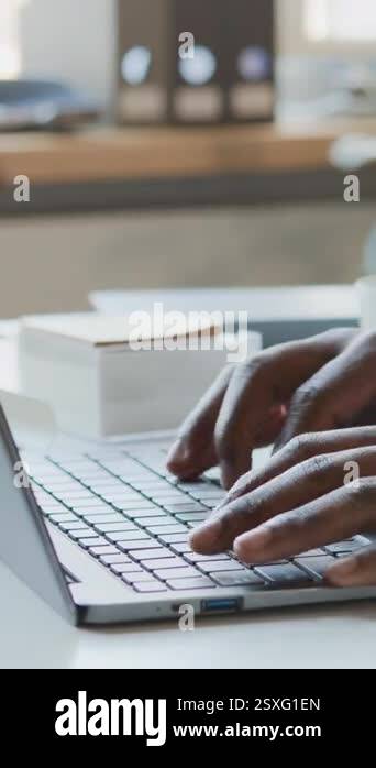 Vertical closeup of hands of unrecognizable black businessman using ...