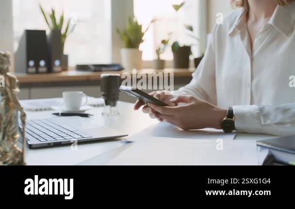 Medium midsection pan shot of anonymous female solicitor or legal ...