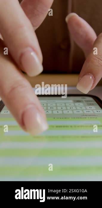 Vertical extreme close up of hands of anonymous young woman using ...