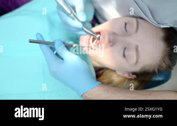 Dentist and patient at modern medical center. Doctor treats a young ...