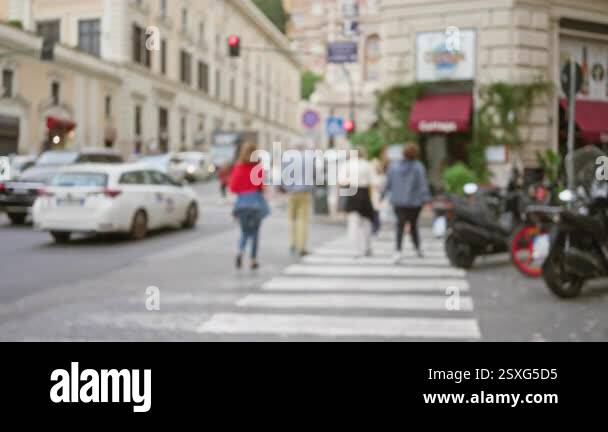 Blurry pedestrians and vehicles on a busy street in rome, italy ...