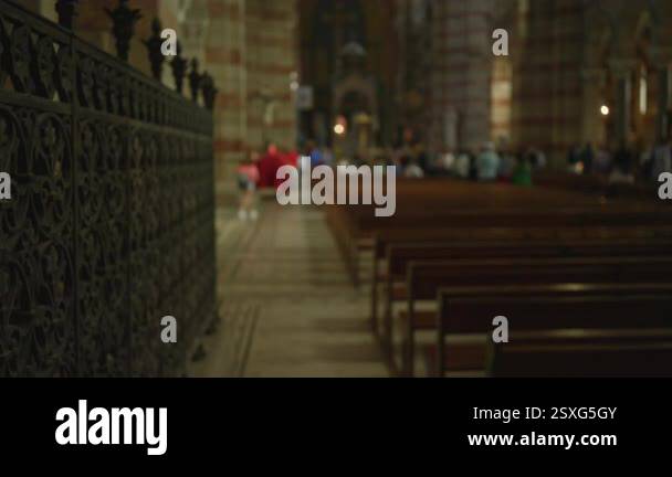 Church interior with blurred congregation, priest in red robes, ornate ...