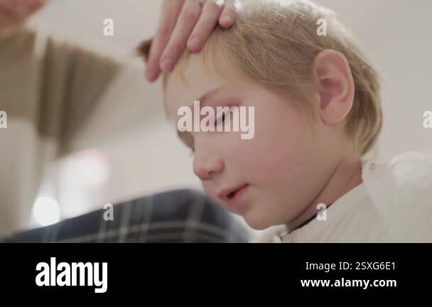 Child getting upset while receiving haircut at home Stock Video Footage ...