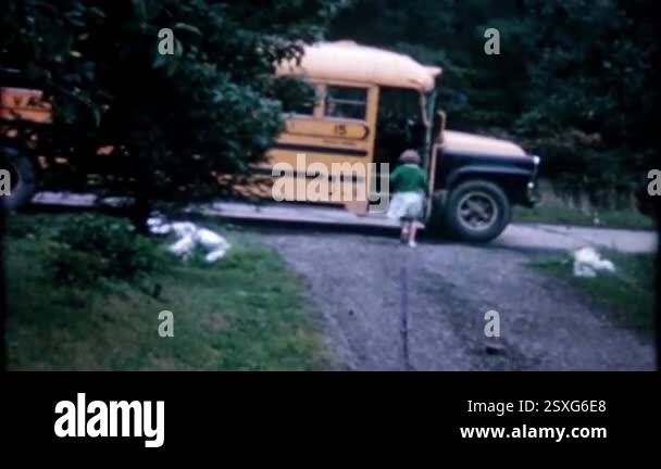 school bus stops on country road and teenage girl quickly climbs up the ...