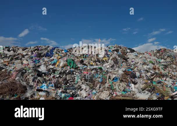 View a massive landfill overflowing with plastic debris and organic ...