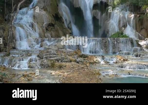 Stunning multi-level waterfall surrounded by lush jungle in Luang ...