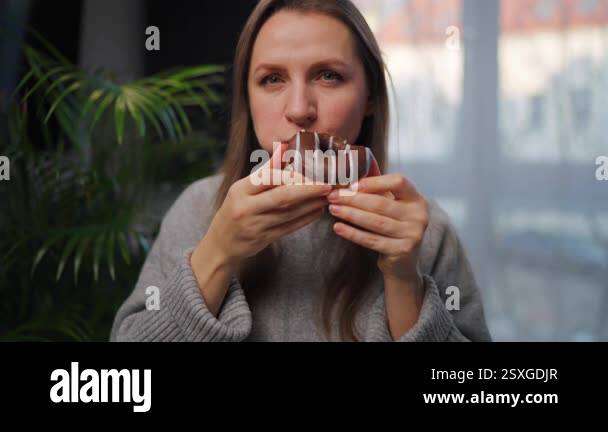 Sweet addiction concept. A woman eats a chocolate donut with morbid ...