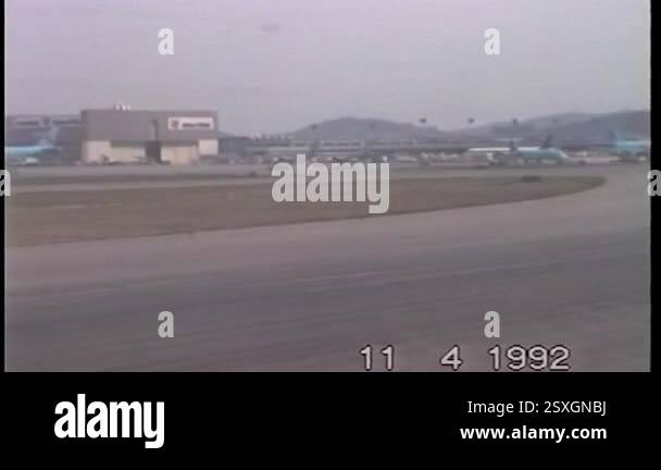 A 1992 video captures a plane landing on an airport runway, showing the ...