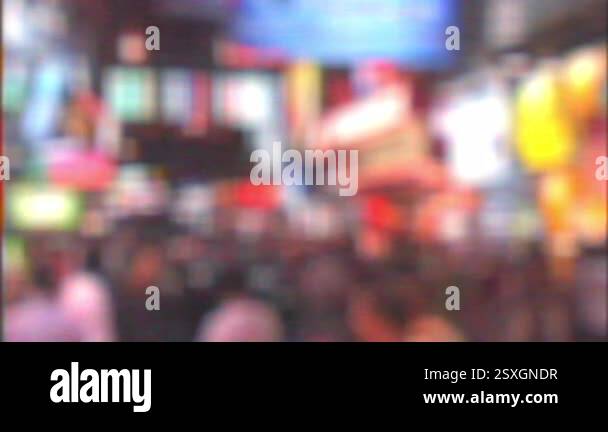 A heavily blurred VHS video captures a bustling nighttime street scene ...