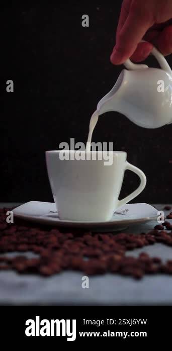 Pouring milk into coffee cup from Ceramic Creamer Pitchers Stock Video ...