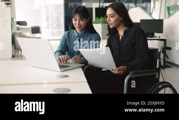 Positive young diverse business colleagues from inclusive company staff working on product ...