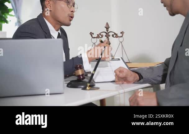 Businessman and lawyer talking and making a contract together Signing a ...