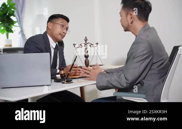 Businessman and lawyer talking and making a contract together Signing a ...